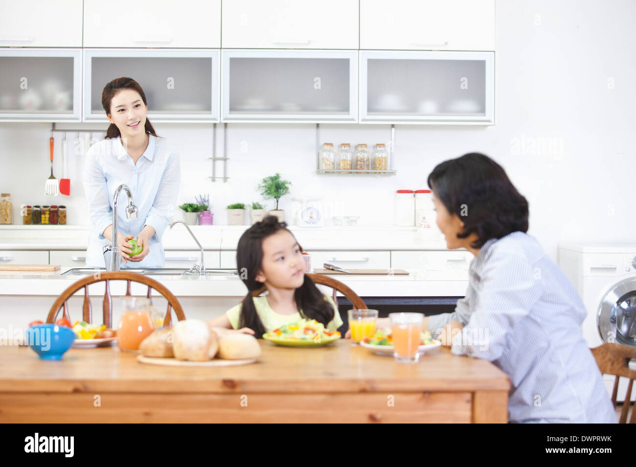 two women and a kid in the kitchen Stock Photo - Alamy