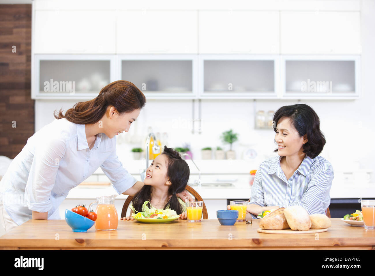 two women and a kid in the kitchen Stock Photo - Alamy