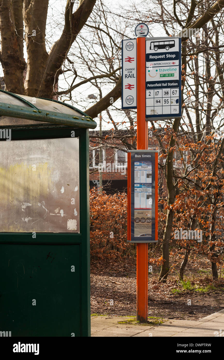 Bus stop with 'change for rail' sign Stock Photo - Alamy
