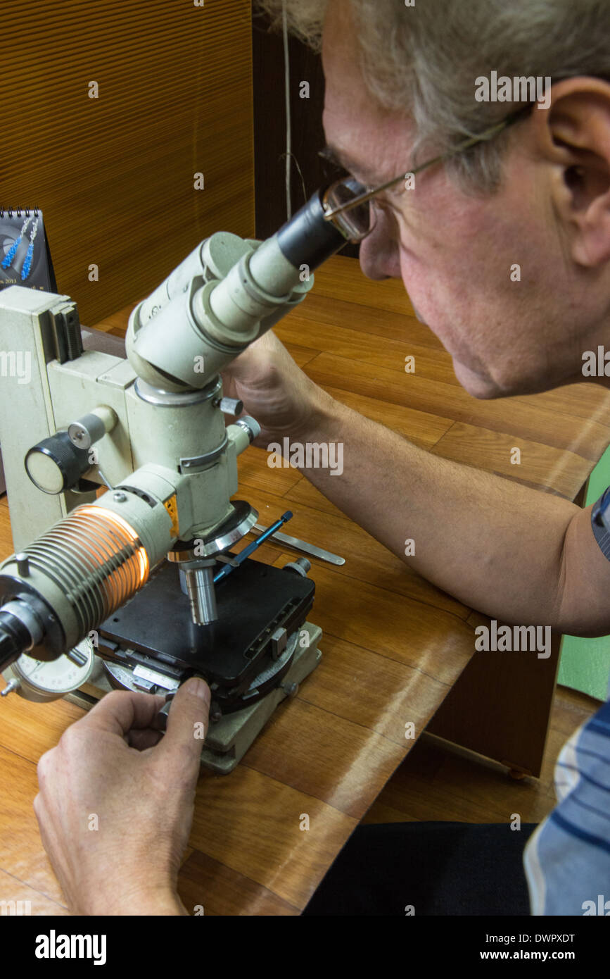 Man look at microsurgical scalpel with diamond blade for ophthalmology ...