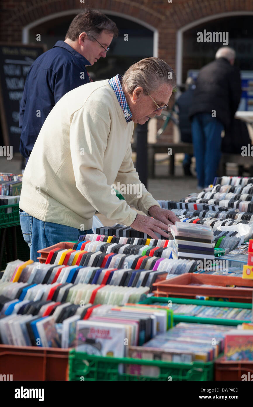 Man searching through DVD's on market stall Stock Photo - Alamy