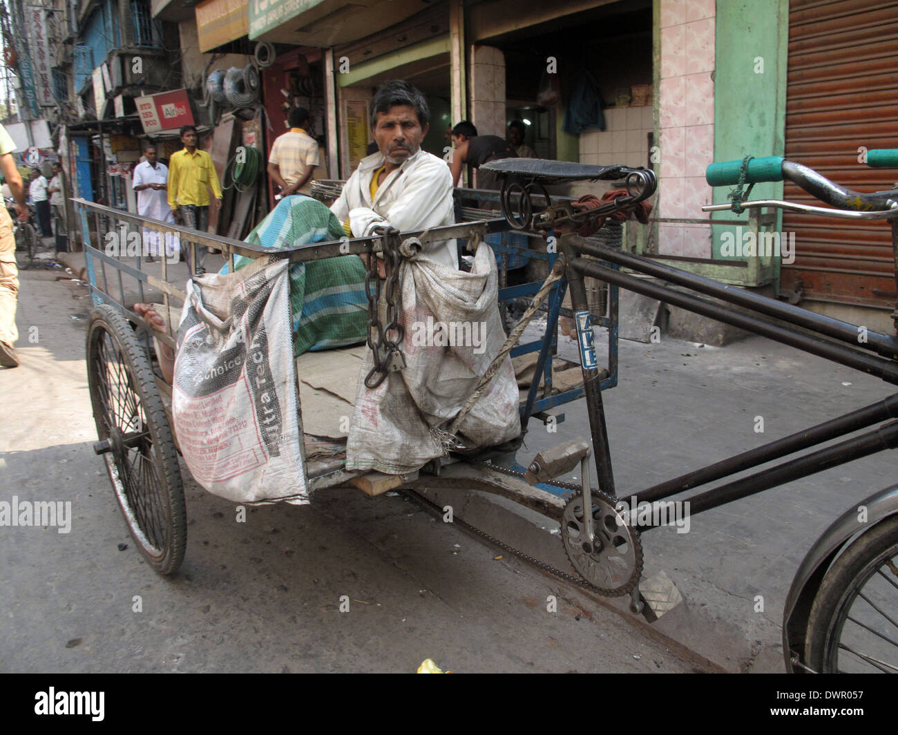 Rickshaw driver wait for passengers on their rickshaw in Kolkata, India ...