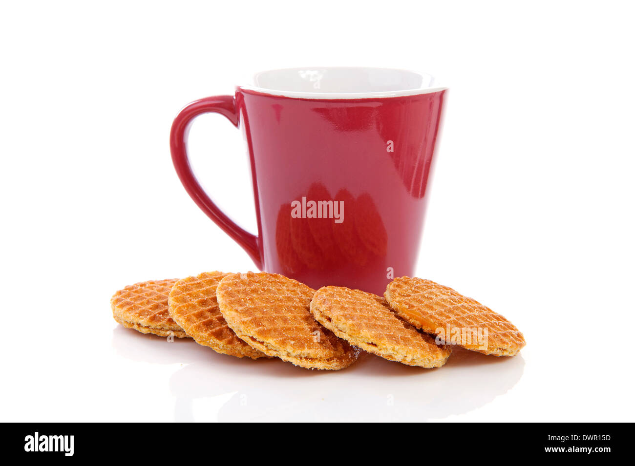 Pile of typical Dutch stroopwafels ( with syrup) near coffee cup over ...