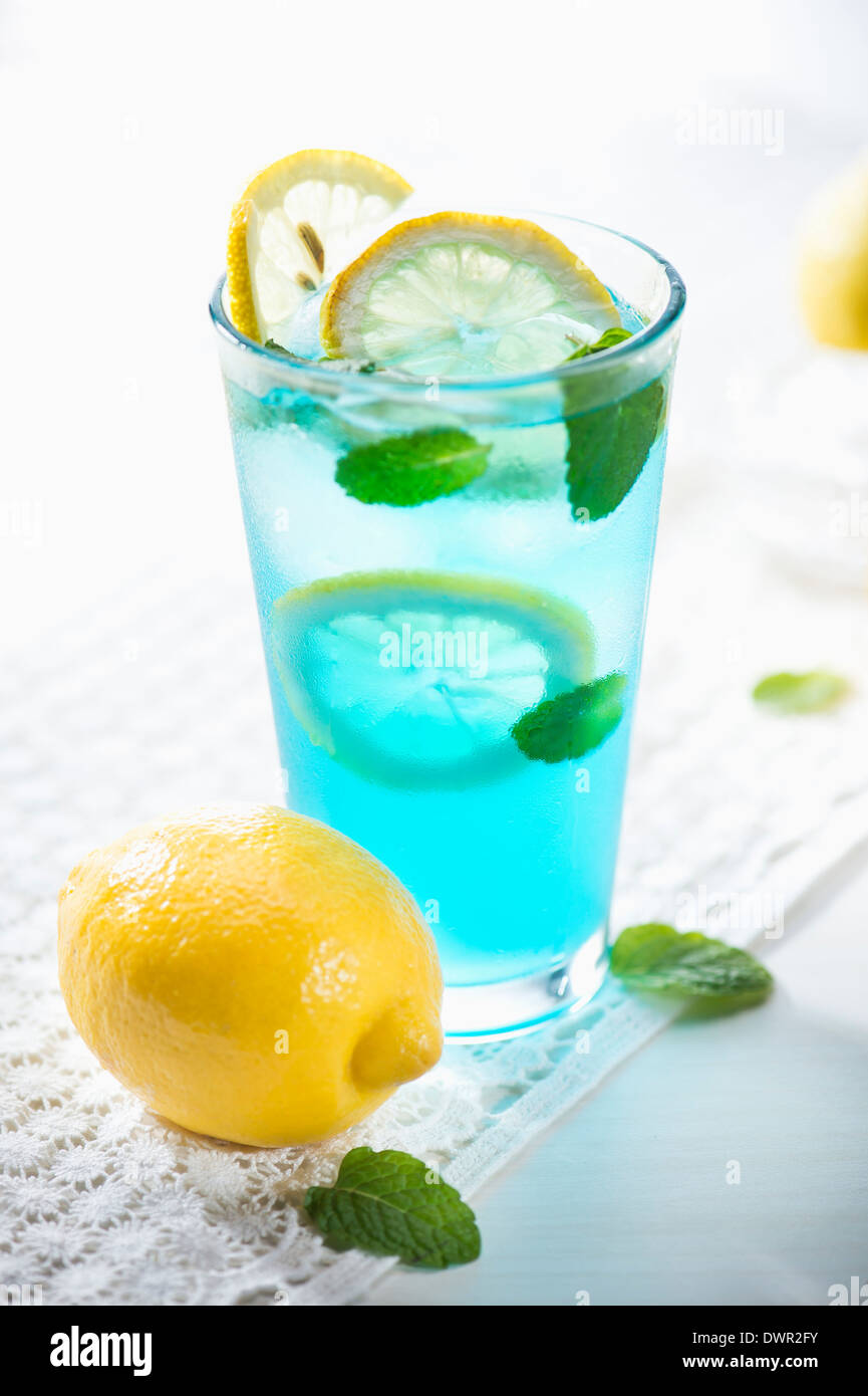 a glass of blue liquid with lemons Stock Photo - Alamy