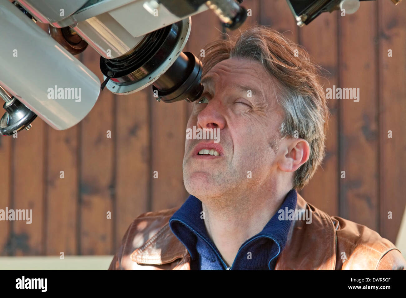 Man looking through a telescope pointed at the sky at Leiden ...
