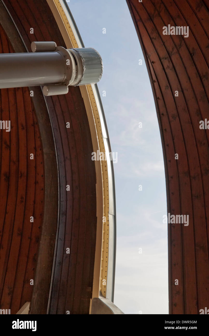 Interior view of an observatory dome and telescope pointed at the sky ...