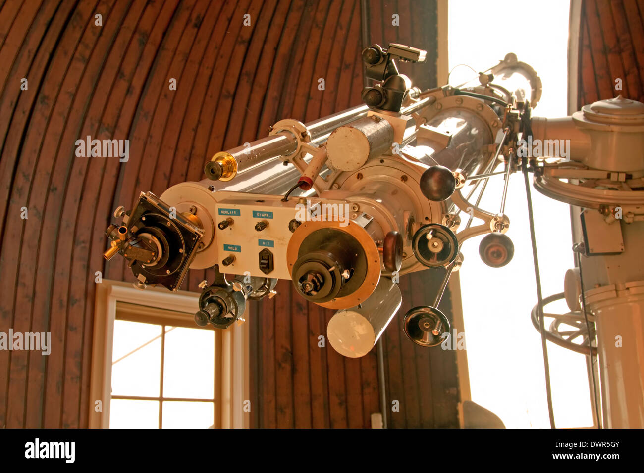 Interior view of an observatory dome and telescope pointed at the sky ...