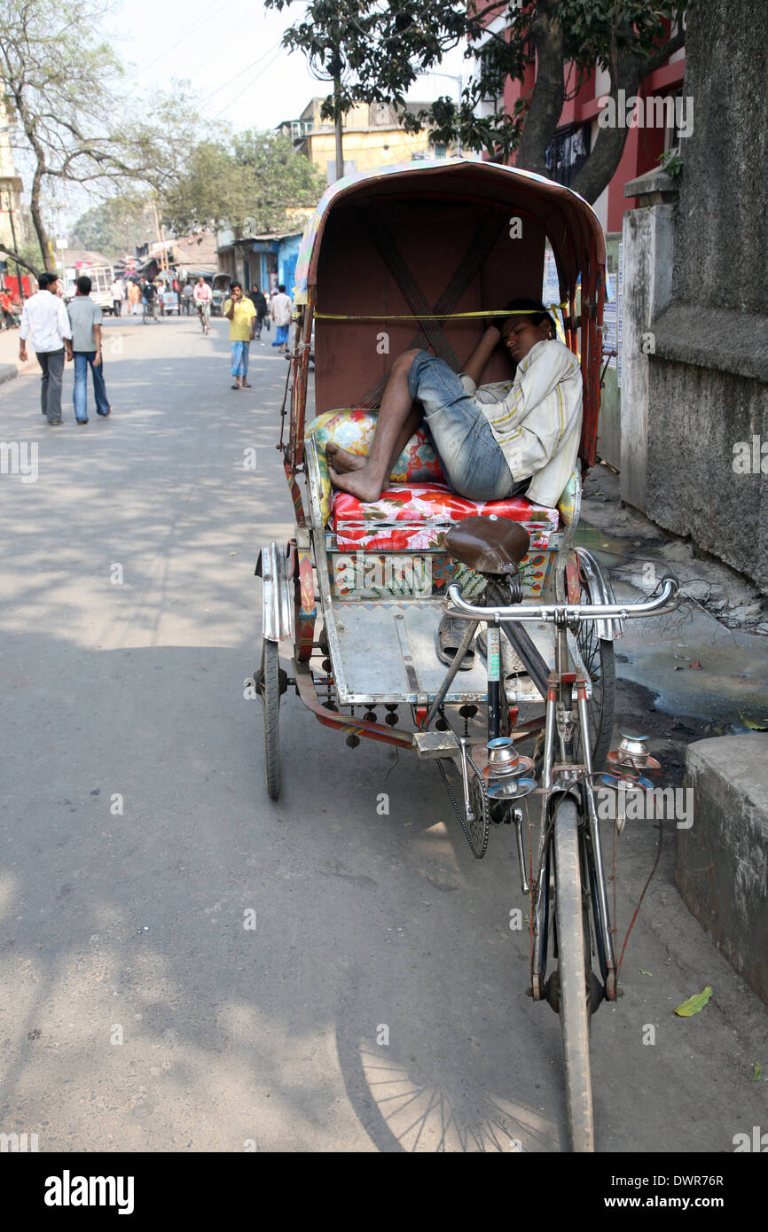 Rickshaw driver wait for passengers on their rickshaw in Kolkata, India ...