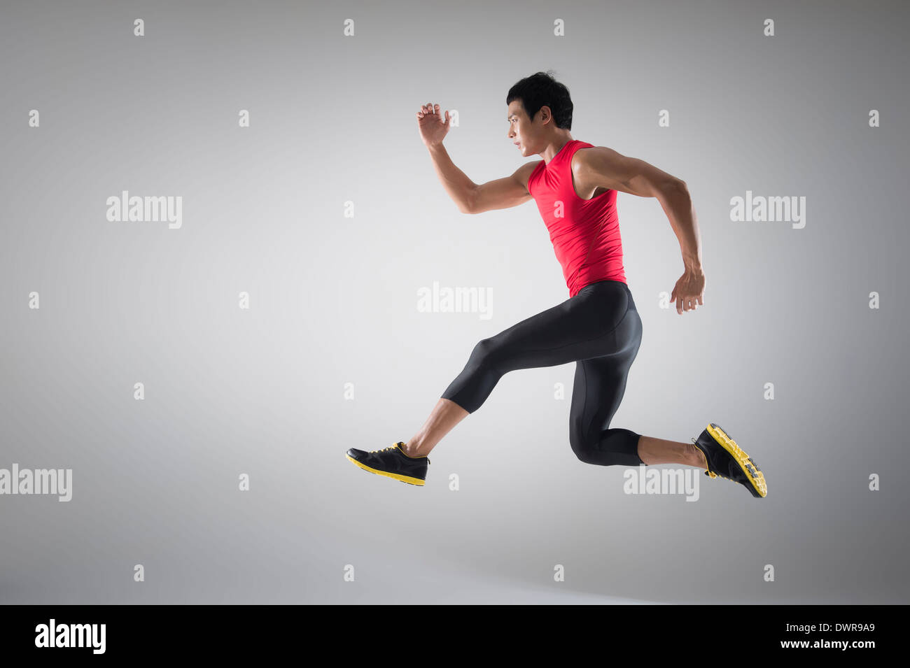 side shot of an athlete jumping Stock Photo - Alamy