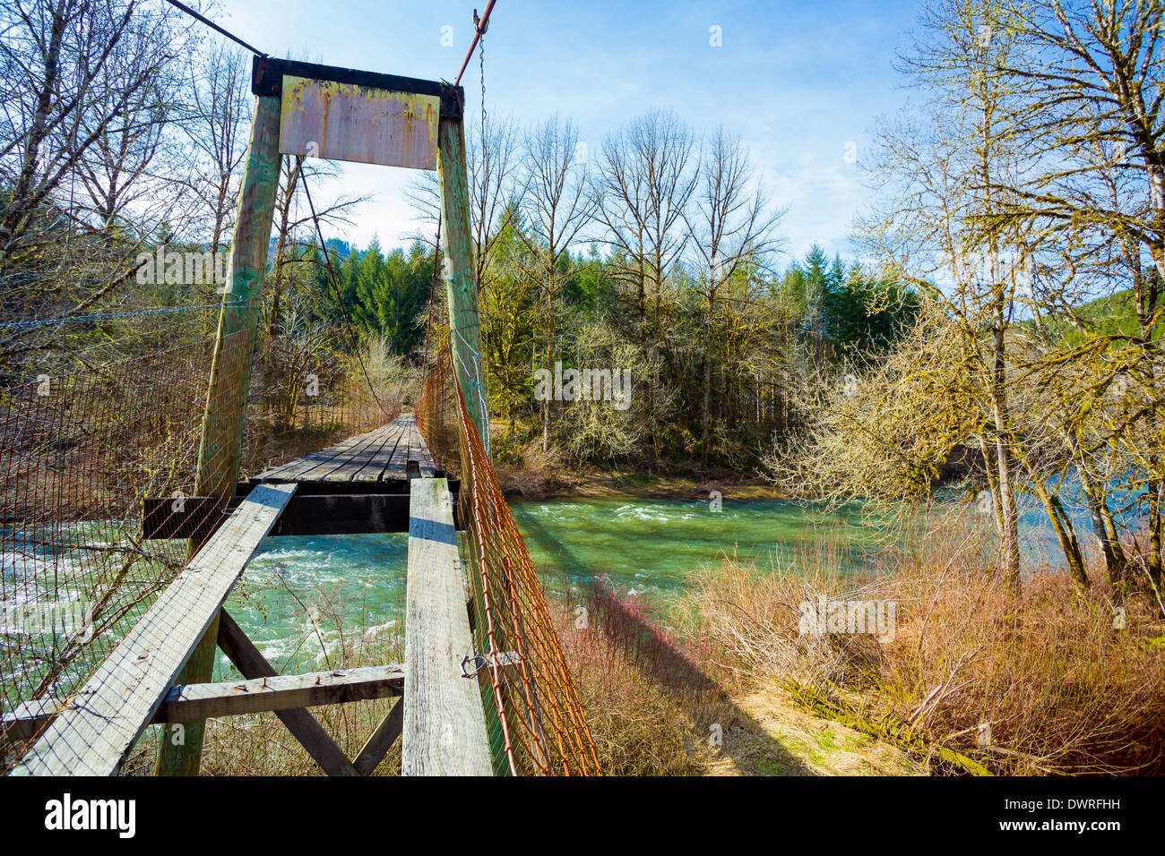 Very old swinging bridge crosses the Siuslaw River near Mapleton Oregon ...