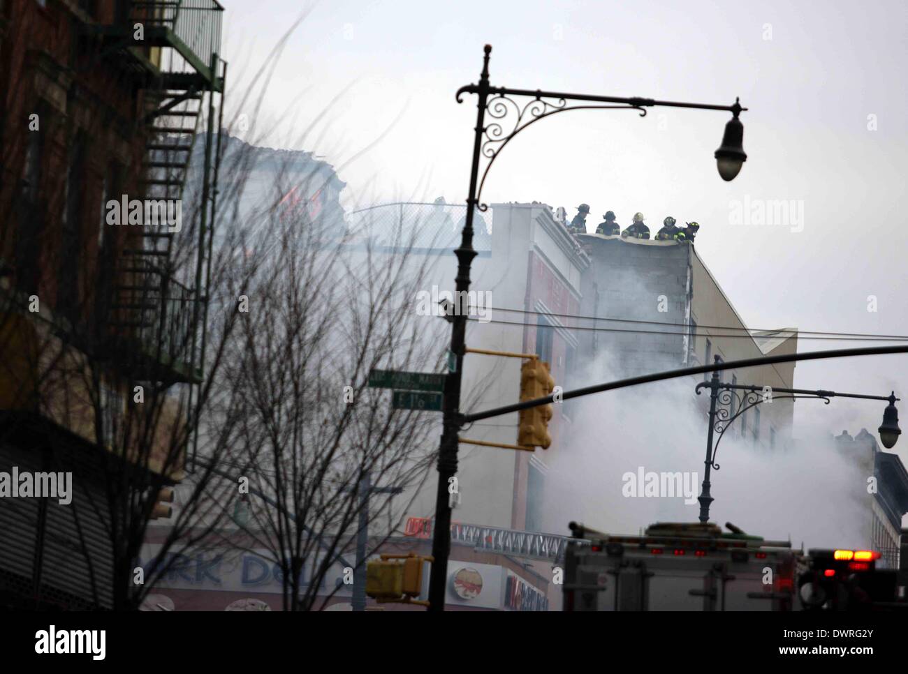 New York, USA. 12th Mar, 2014. Firefighters work at the site of ...