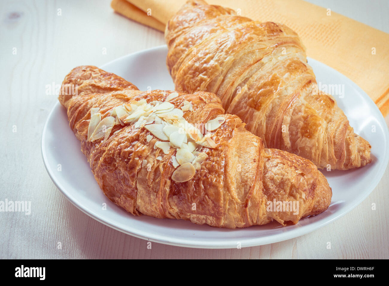 Fresh croissants on a plate. Toning in vintage style Stock Photo - Alamy