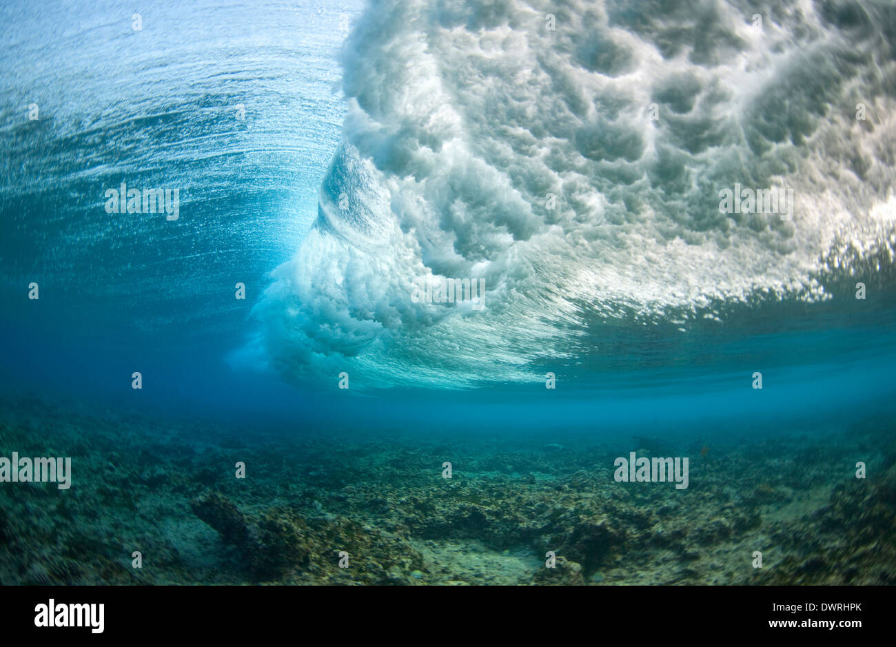 Unique underwater view of a wave breaking over a reef in the Maldives ...