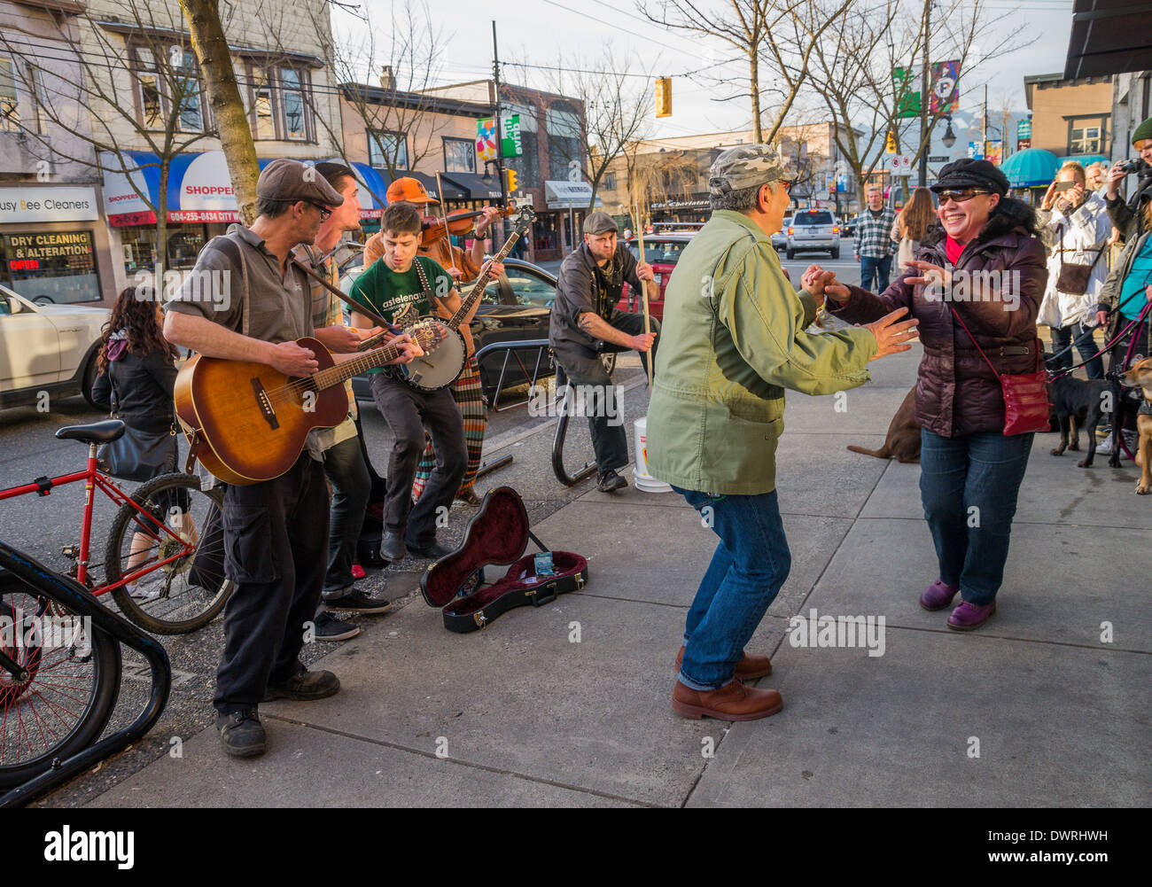 Couple dancing on the street to music of buskers, Commercial Drive ...