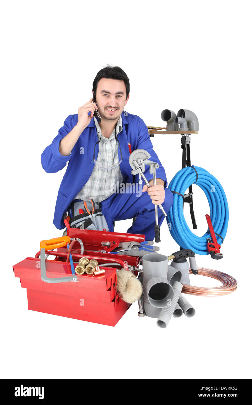 Plumber with a toolbox and cellphone Stock Photo - Alamy