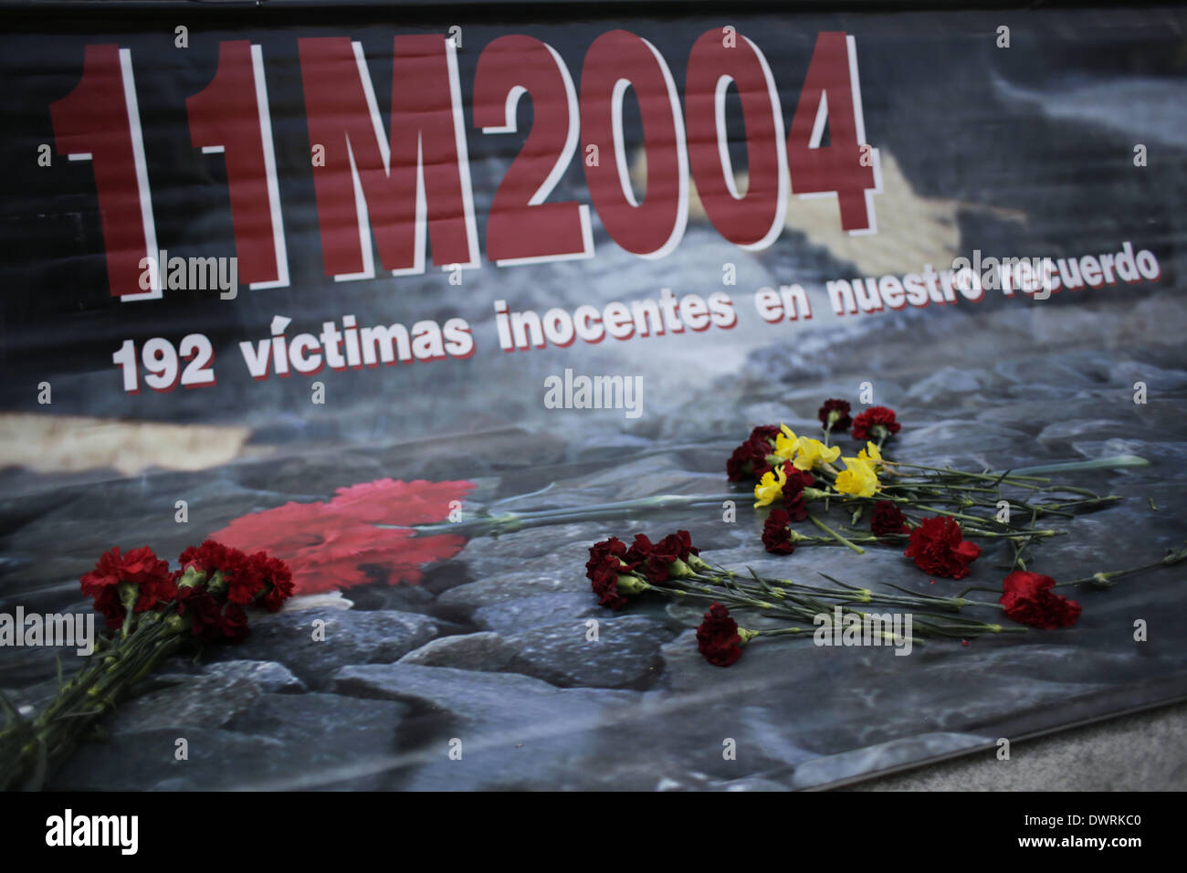 Madrid, Spain. 11th Mar, 2014. Flowers are left on a banner that sais ...