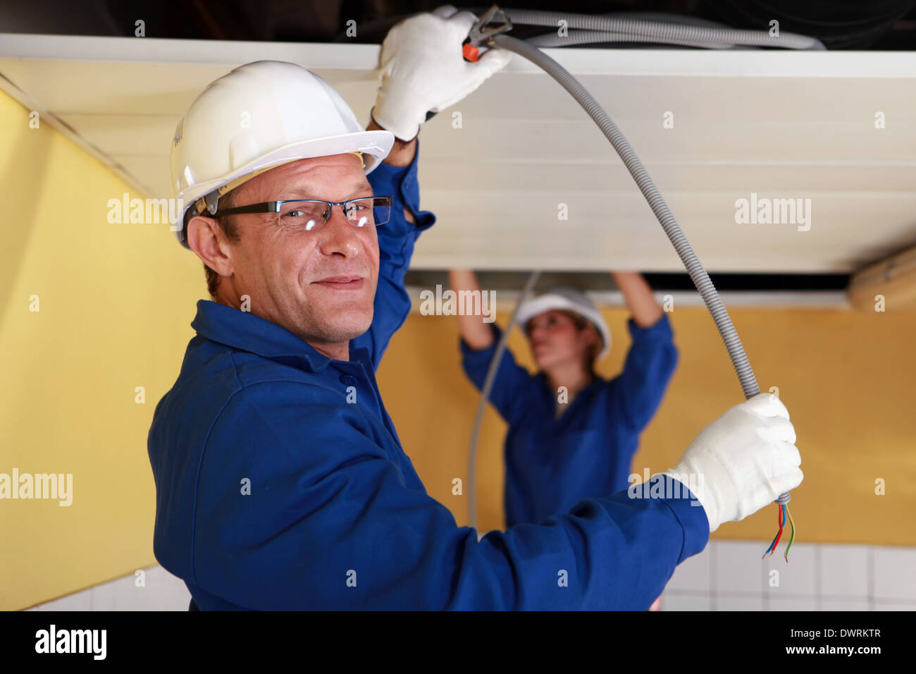Electricians at work Stock Photo - Alamy