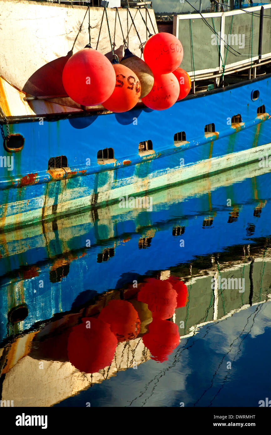 Red Buoys Blue Boat Stock Photo - Alamy