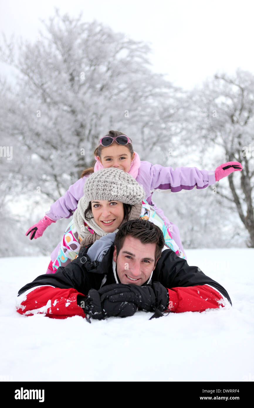 Family laying down in the snow Stock Photo - Alamy