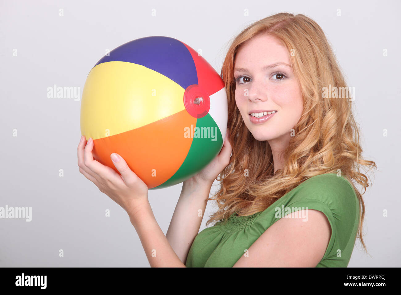 Girl holding beach ball Stock Photo - Alamy