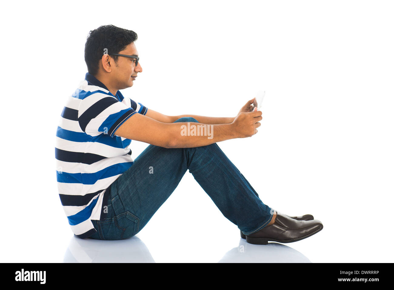 Indian boy sitting floor Cut Out Stock Images & Pictures - Alamy