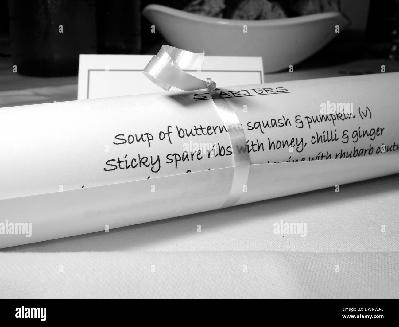 A menu rolled up on the table ready for the celebrations to begin Stock ...