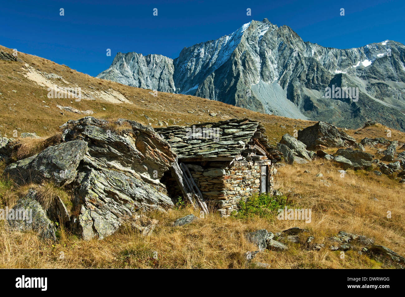 Shephard stone hut in the Val d'Hérens valley, peak Dent de Perroc ...