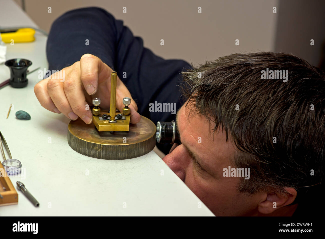Watchmaker checks parts of a wristwatch, Manufacture d'horlogerie ...