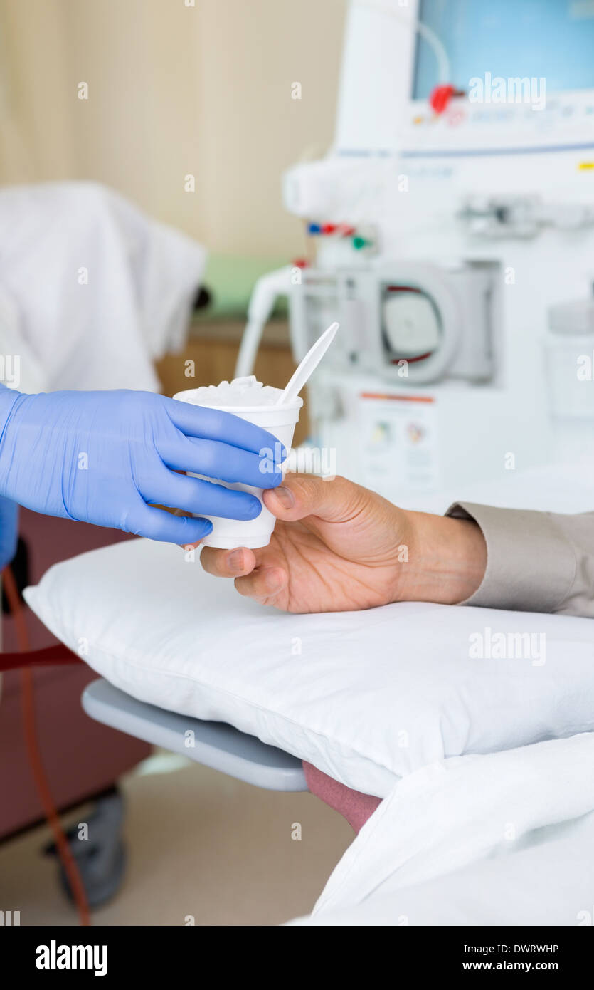 Nurse Giving Crushed Ice To Patient On Renal Dialysis Stock Photo - Alamy