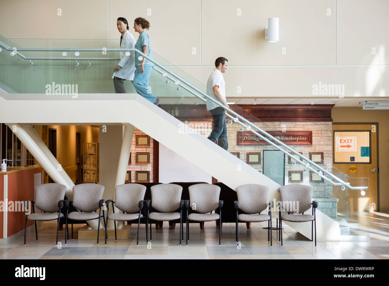 Medical Team And Man Using Staircase In Hospital Stock Photo - Alamy