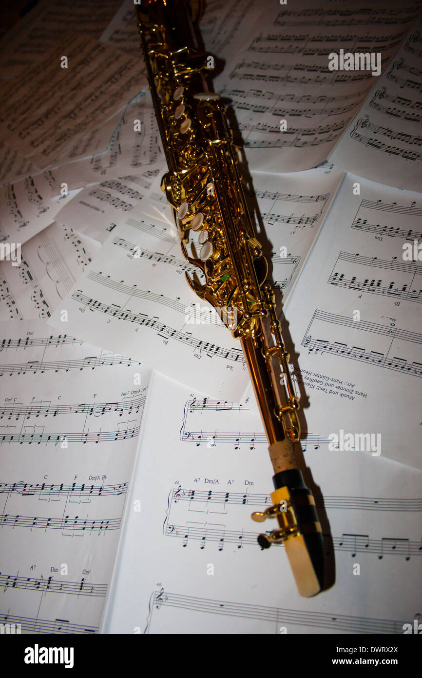 A soprano saxophone lying on sheet music Stock Photo - Alamy