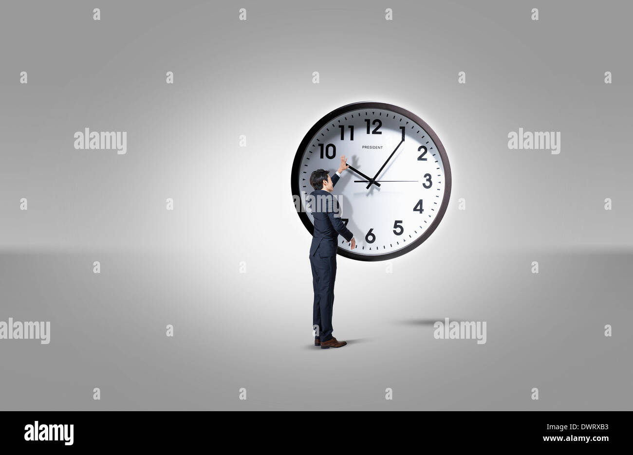 a man fixing clock hand Stock Photo - Alamy