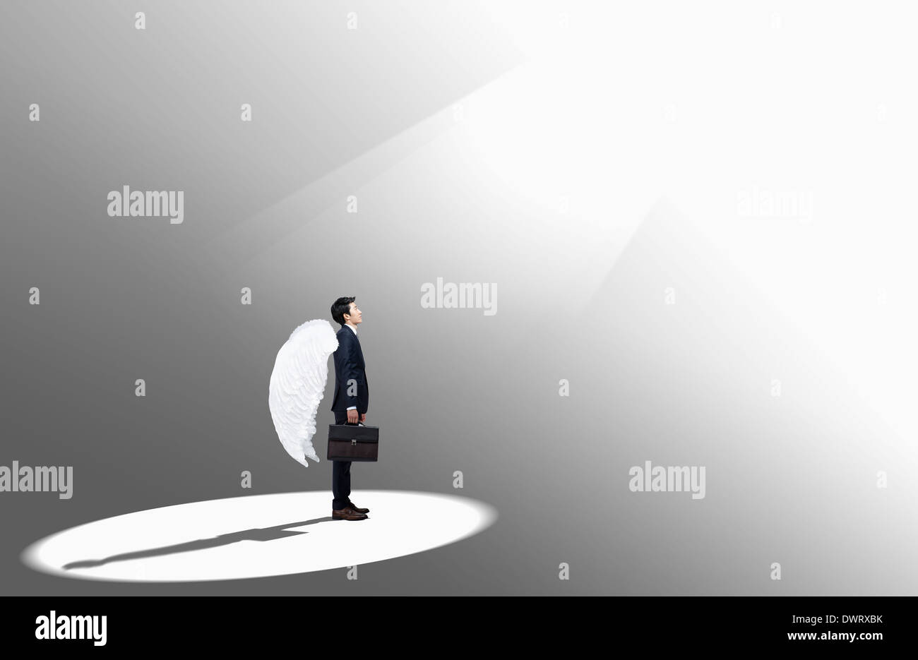a businessman standing under a light Stock Photo - Alamy