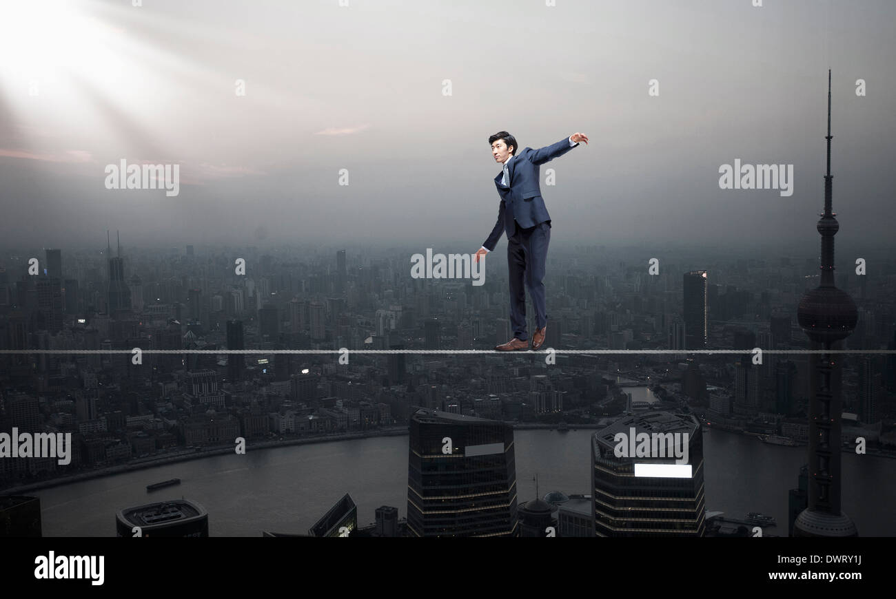 a businessman walking on a string in China Stock Photo - Alamy
