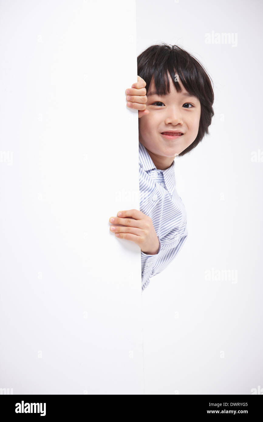 a kid hiding behind a white wall Stock Photo - Alamy