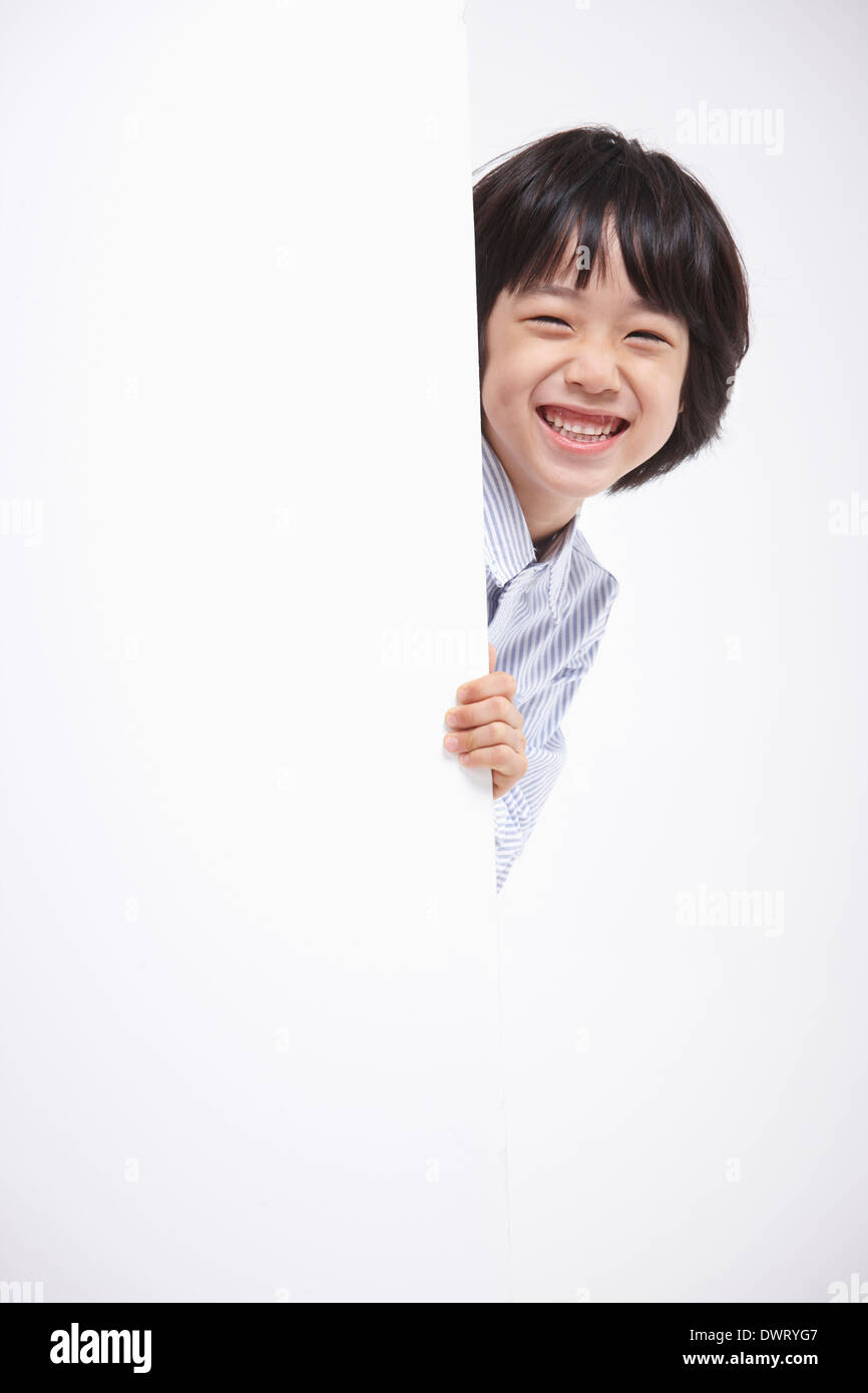 a kid hiding behind a white wall Stock Photo - Alamy
