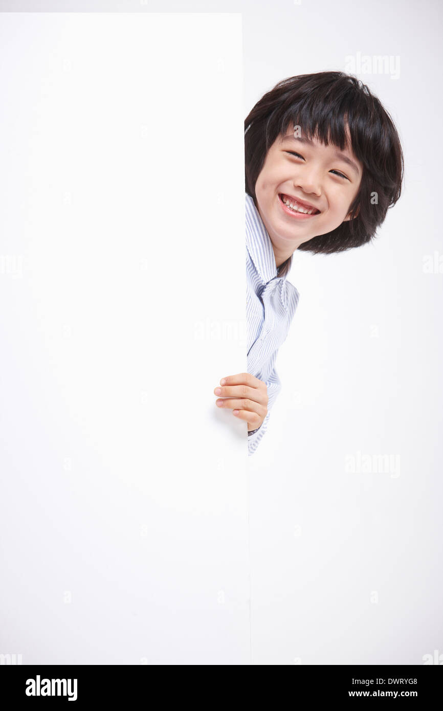 a kid hiding behind a white wall Stock Photo - Alamy