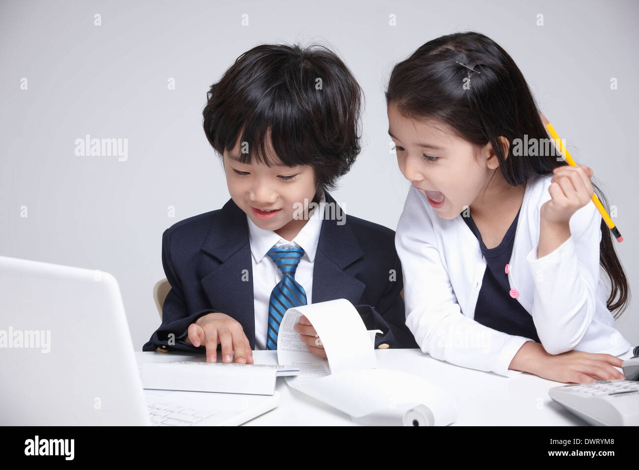 kids wearing business suit working together using a laptop Stock Photo ...