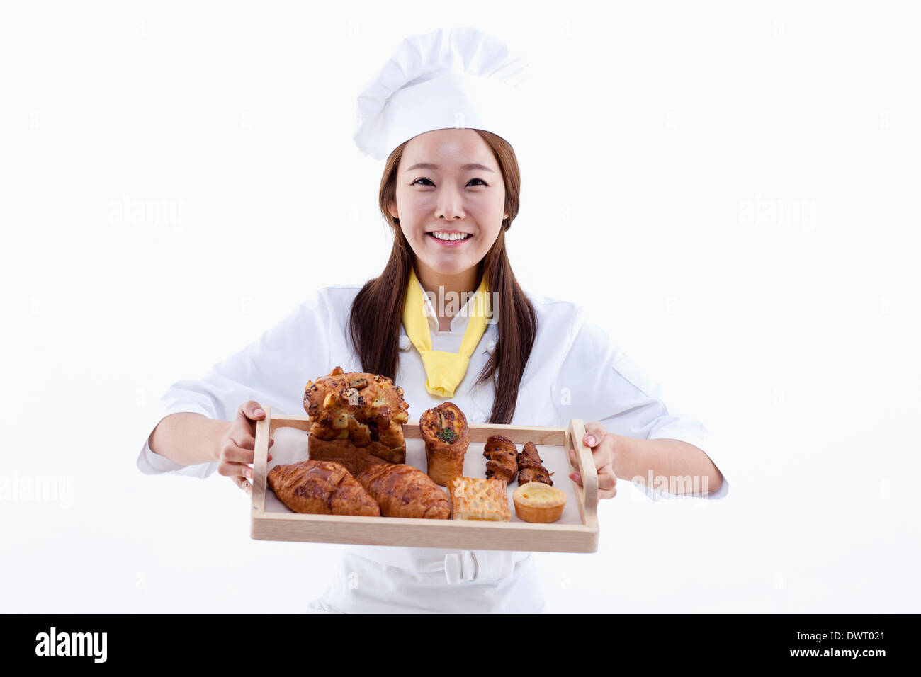 a female pastry chef holding a tray of bread Stock Photo - Alamy