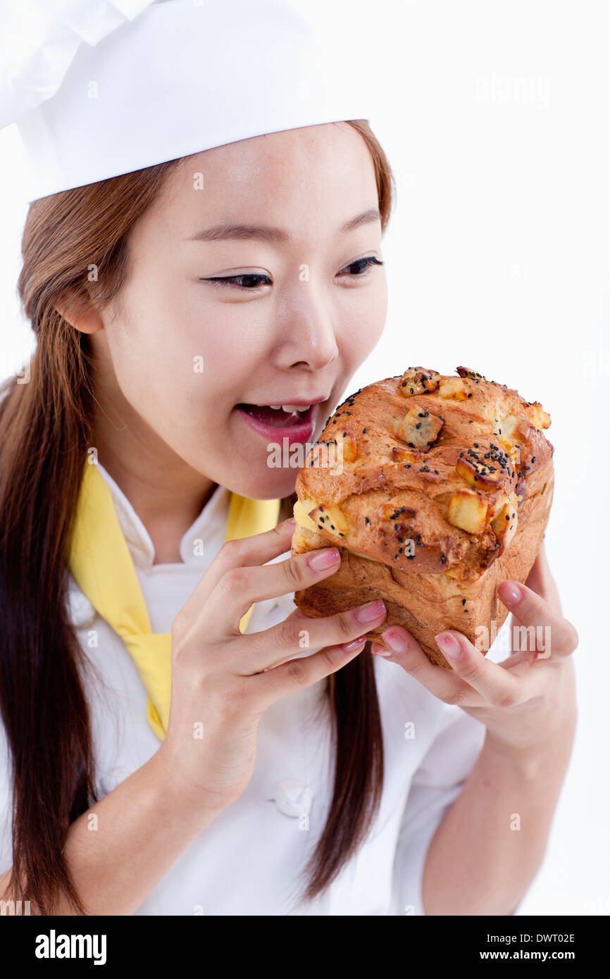 a female pastry chef holding bread Stock Photo - Alamy