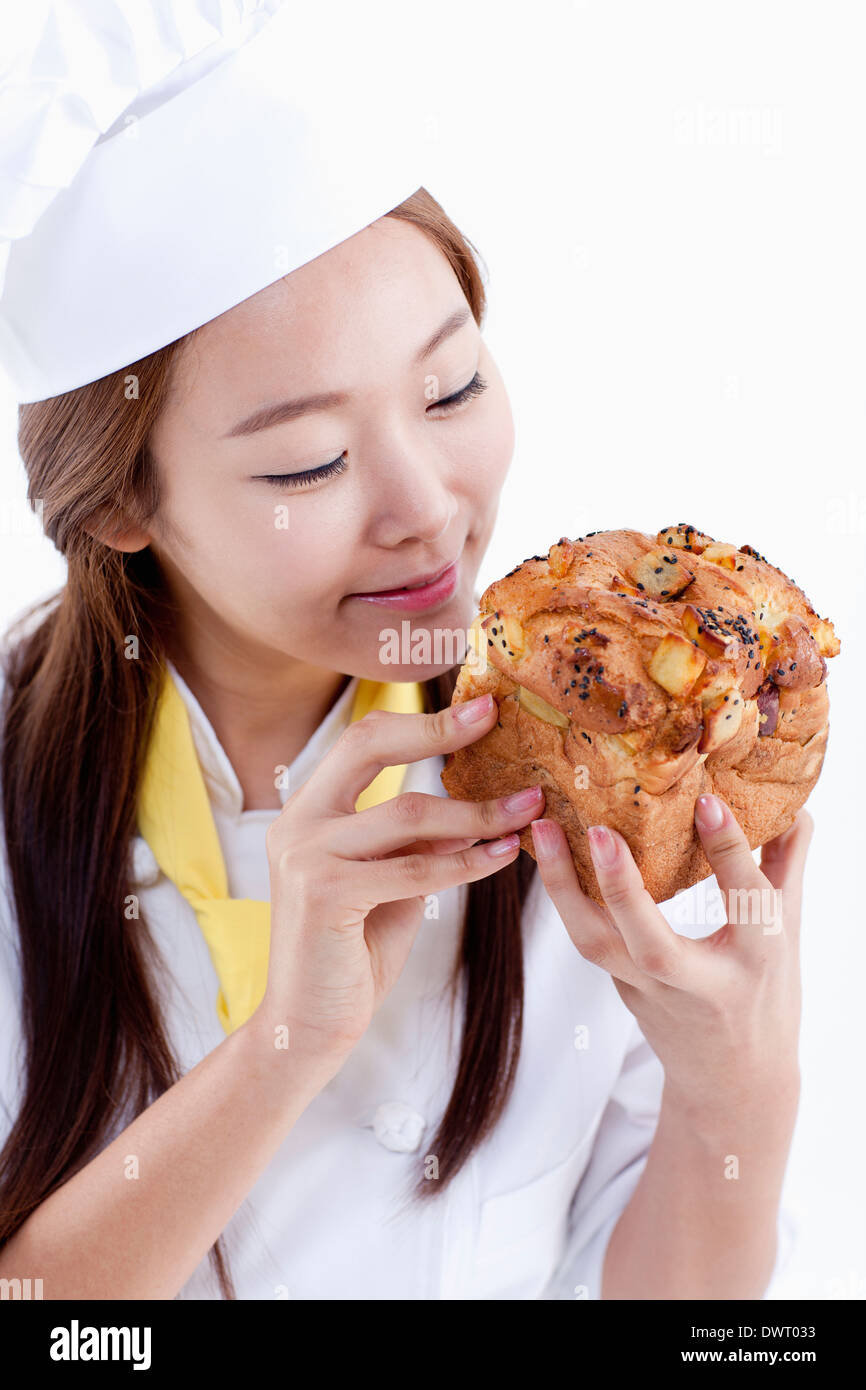 a female pastry chef holding bread Stock Photo - Alamy