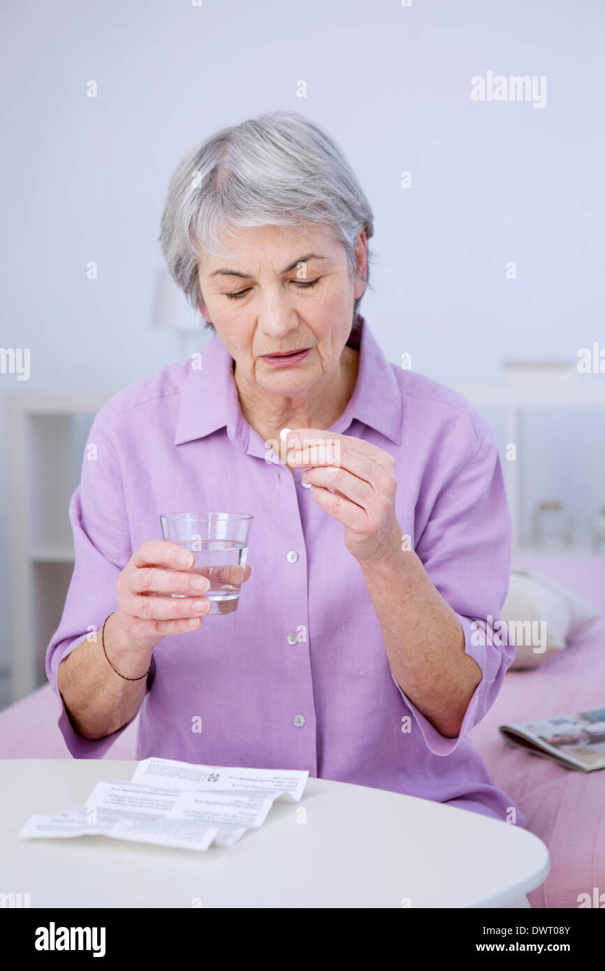 Elderly person taking medication Stock Photo - Alamy