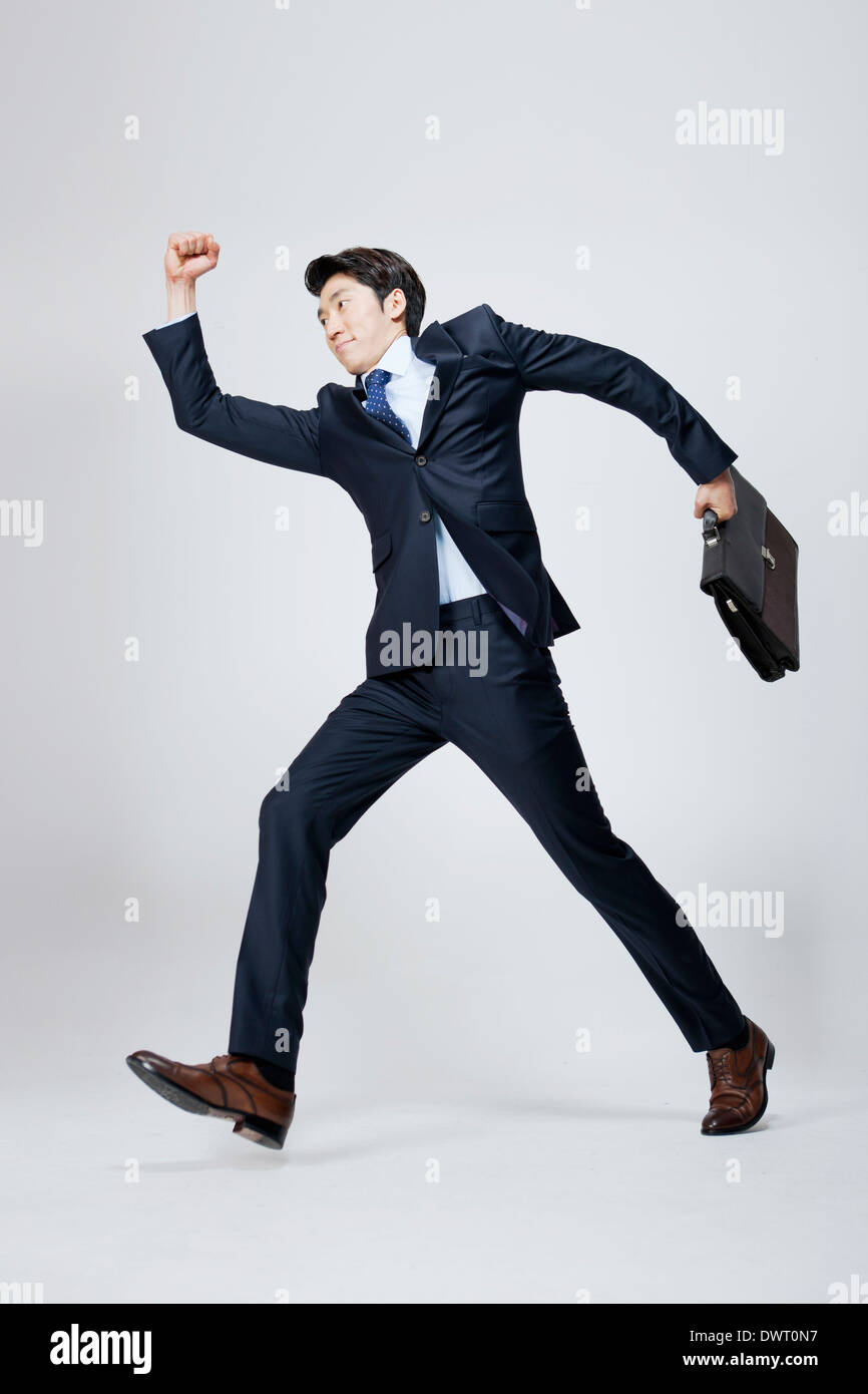 a businessman running with business case Stock Photo - Alamy