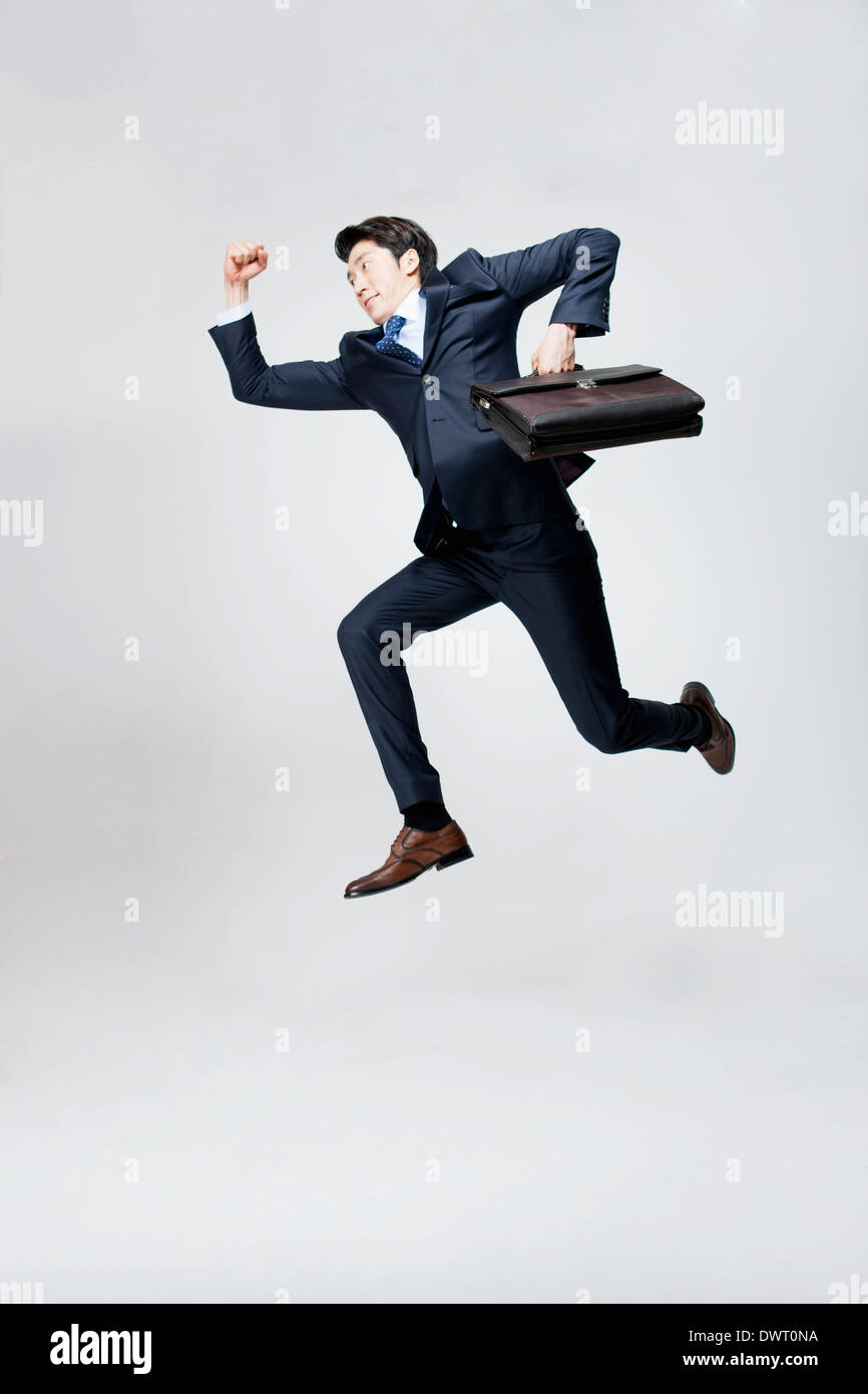 a businessman running with business case Stock Photo - Alamy
