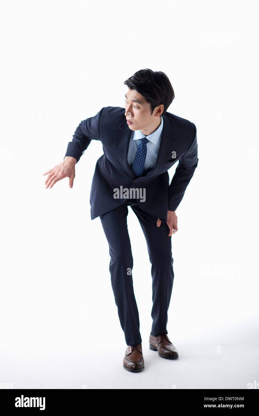 a businessman bending down Stock Photo - Alamy