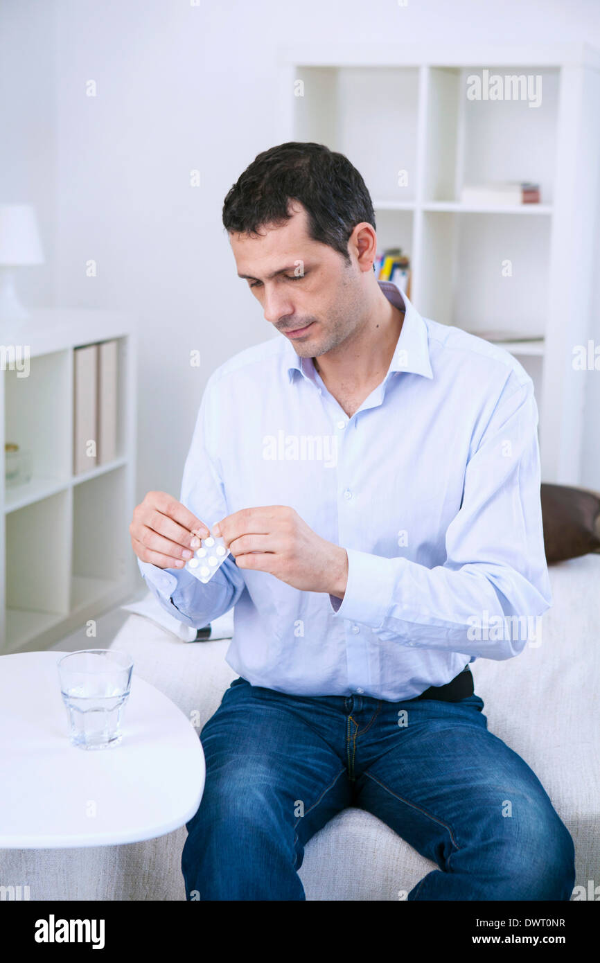 Man taking medication Stock Photo - Alamy