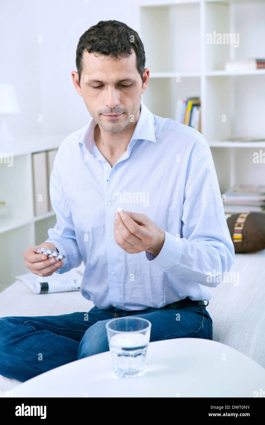 Man taking medication Stock Photo - Alamy