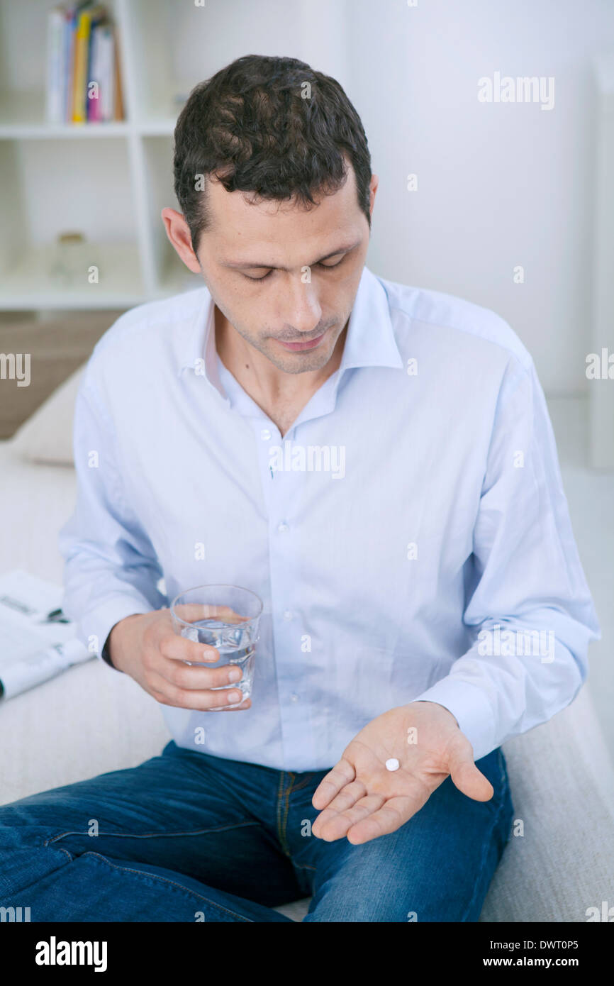 Man taking medicine hi-res stock photography and images - Alamy