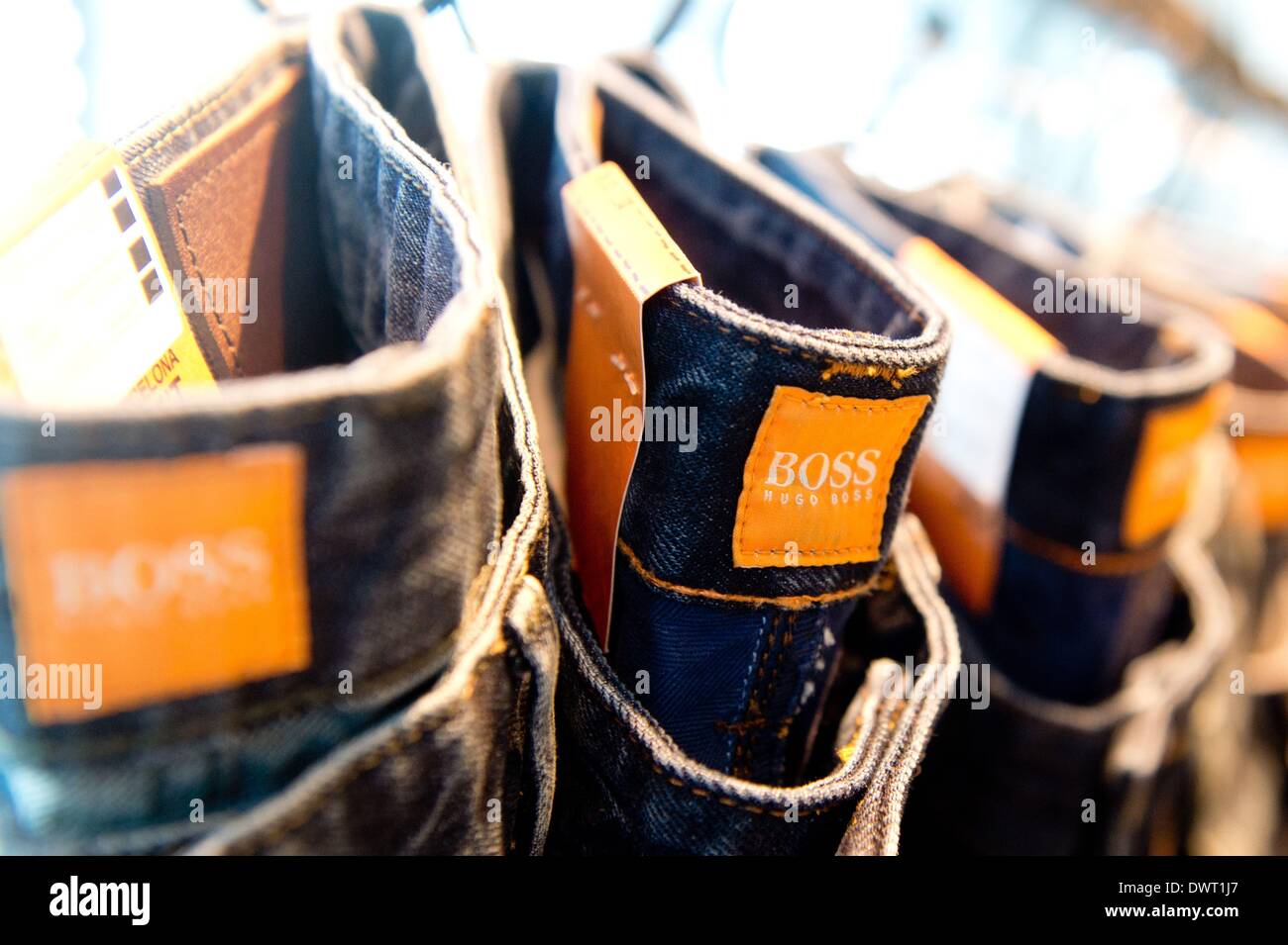 Jeans on hangers at the headquarters of the German fashion company in ...