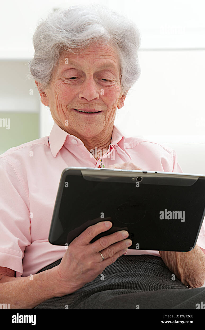 Elderly person with tablet Stock Photo - Alamy